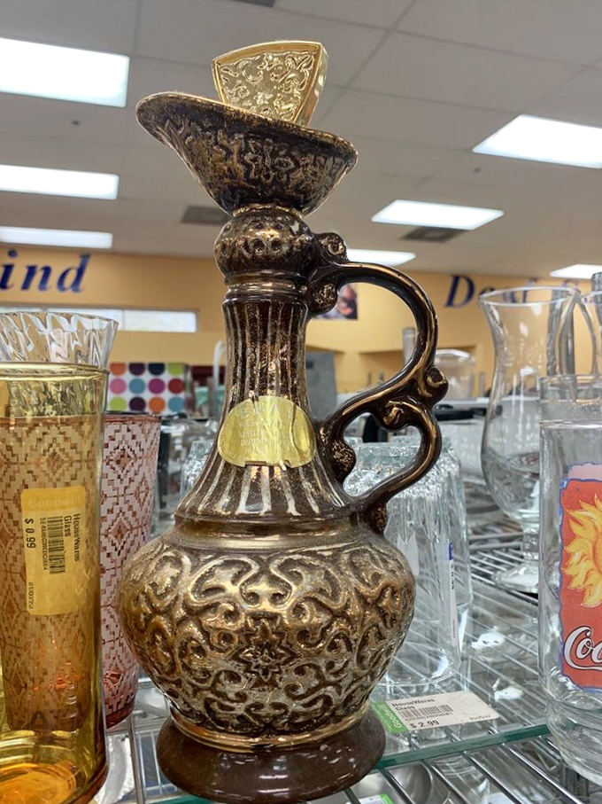 This ornate vessel looks like it belongs in Aladdin's cave of wonders, not between Coca-Cola glasses on a wire shelf.