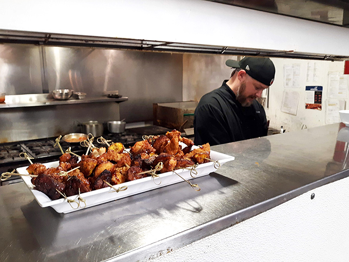 Behind the scenes magic: where humble ingredients transform into memorable meals. The chef's focused concentration reveals why every plate arrives with such consistent perfection.