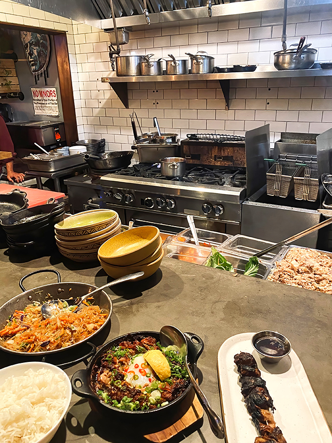 The open kitchen reveals the heart of operations, where traditional techniques meet modern presentation flawlessly.