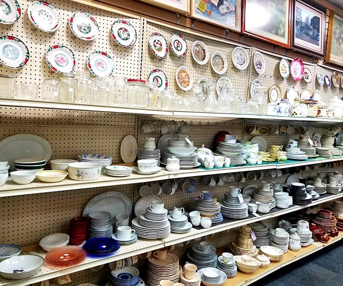 Dish sets and decorative plates create a ceramic rainbow. Grandma's china has nothing on this magnificent wall of mismatched dinnerware perfection.