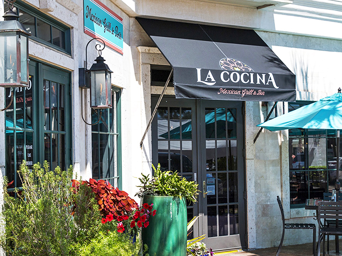 La Cocina's vibrant entrance, framed by colorful plantings, beckons with promises of margaritas and Mexican flavors that taste even better with Gulf breezes.