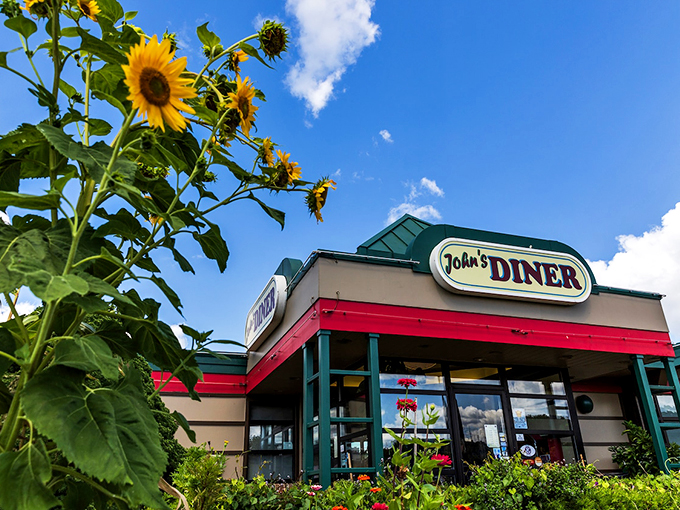 Sunflowers stand sentinel outside a classic American diner, where breakfast conversations have solved the world's problems for generations.
