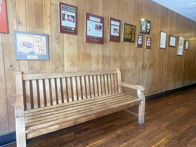 The wooden bench and framed memorabilia aren't calculated nostalgia&mdash;they're authentic artifacts from decades of serving the Pasadena community.