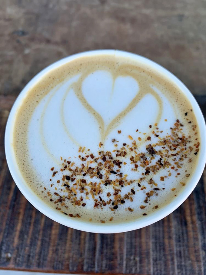 Latte art that speaks to the soul&mdash;a heart-shaped foam masterpiece sprinkled with what appears to be cinnamon crumble.