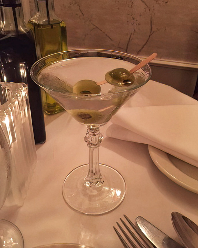 A classic martini with olives standing at attention&mdash;the James Bond of cocktails, sophisticated and dangerous in all the right ways.