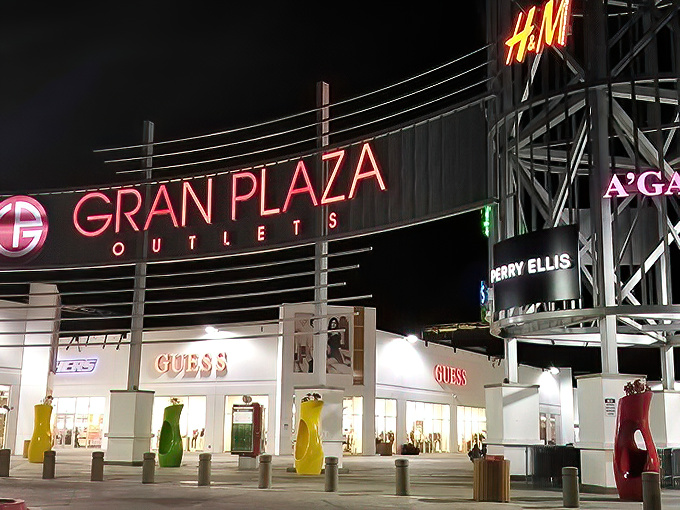 The neon glow of Gran Plaza by night transforms ordinary shopping into something that feels deliciously clandestine, like a midnight raid on fashion's secret vault.