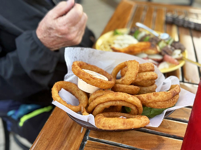 Golden, crispy onion rings that could make a vegetarian question their life choices. The perfect sidekick to whatever seafood masterpiece awaits.