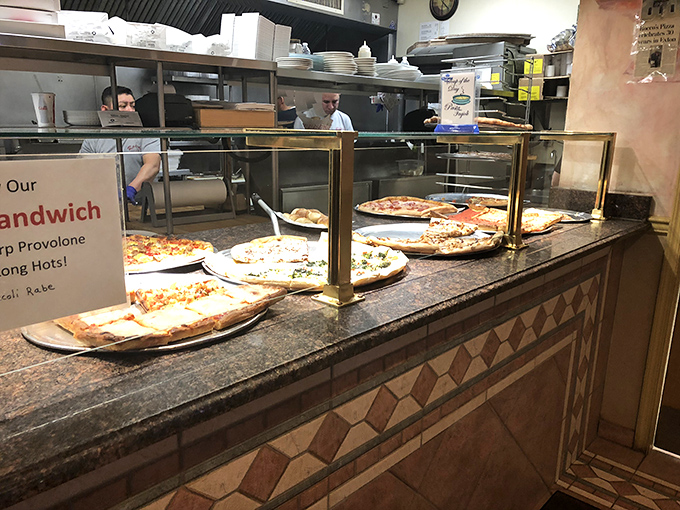 Where the magic happens! Fresh pizzas lined up like edible works of art, waiting for their moment to shine. The open kitchen proves Rocco's has nothing to hide.