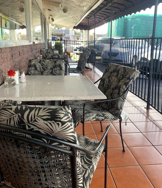 The outdoor patio offers California sunshine with your comfort food. Those tropical-print chairs say "vacation" even on a Tuesday morning.