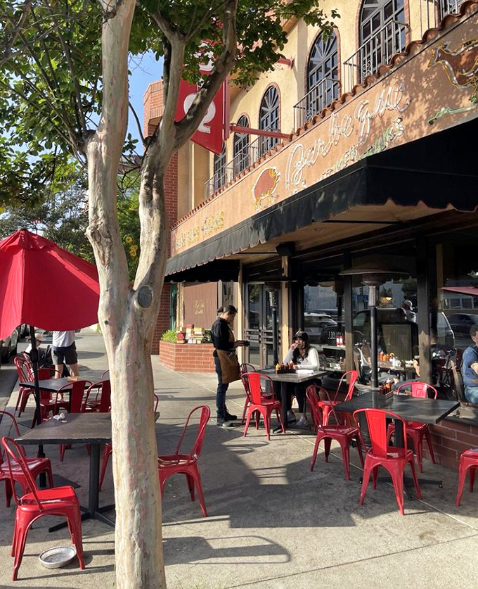 Red chairs under California sunshine—the perfect setting for that post-barbecue moment when you're too full to move but too happy to care.