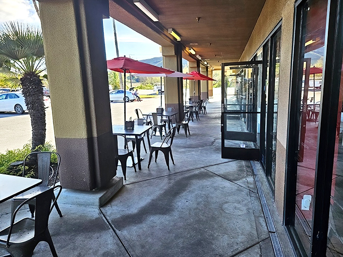 The outdoor seating where sauce-stained fingers are a badge of honor. Those red umbrellas aren't just for shade&mdash;they're warning signals for the flavor explosion ahead.