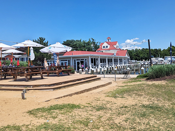 The restaurant's expansive outdoor area offers multiple ways to enjoy the bay &ndash; from sandy beach seating to covered deck dining for the sun-shy.