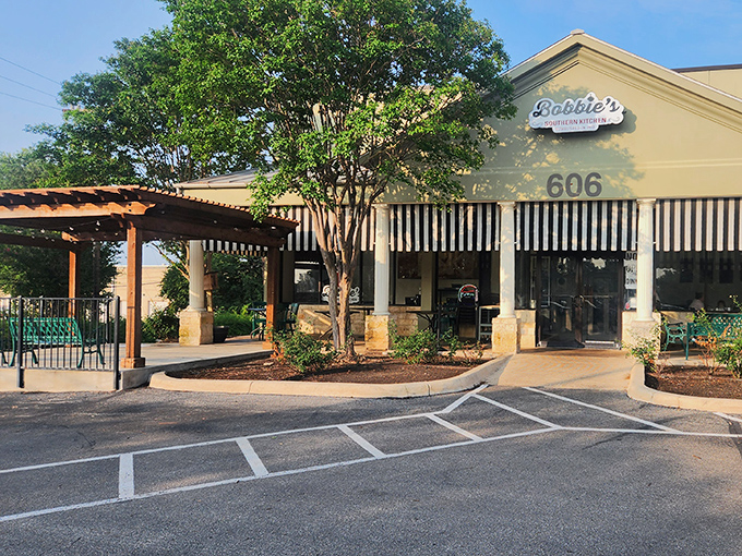 Morning light hits those classic awnings just right, creating the universal signal for "get in here before the breakfast rush claims all the biscuits."