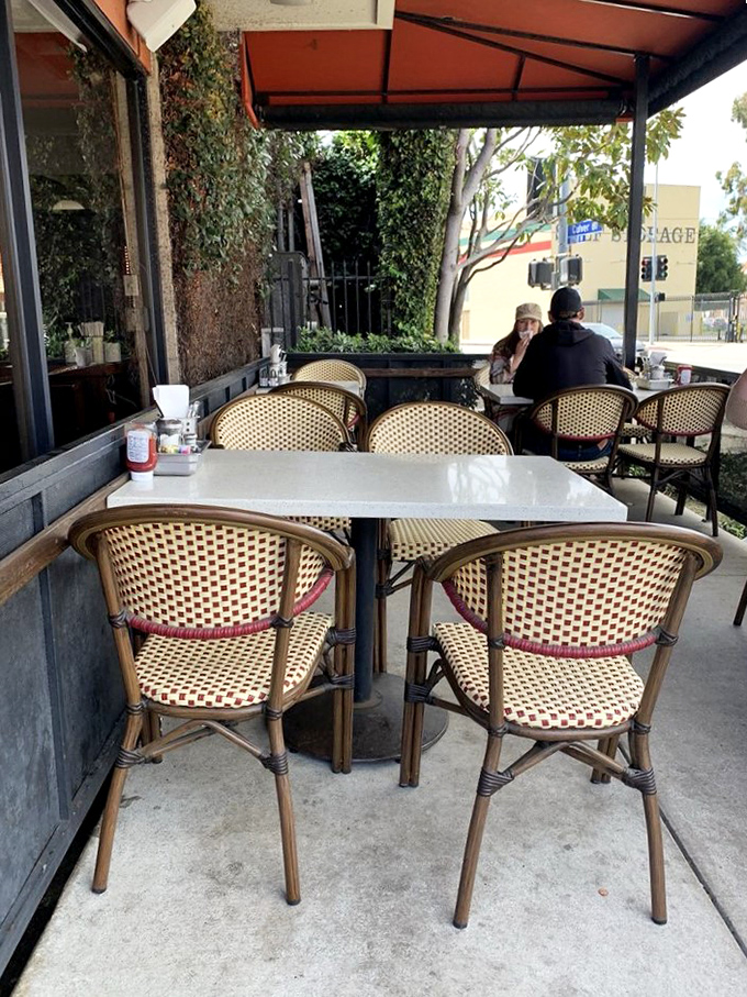 The outdoor seating area &ndash; where people-watching and egg-eating come together in perfect California harmony under filtered sunlight.