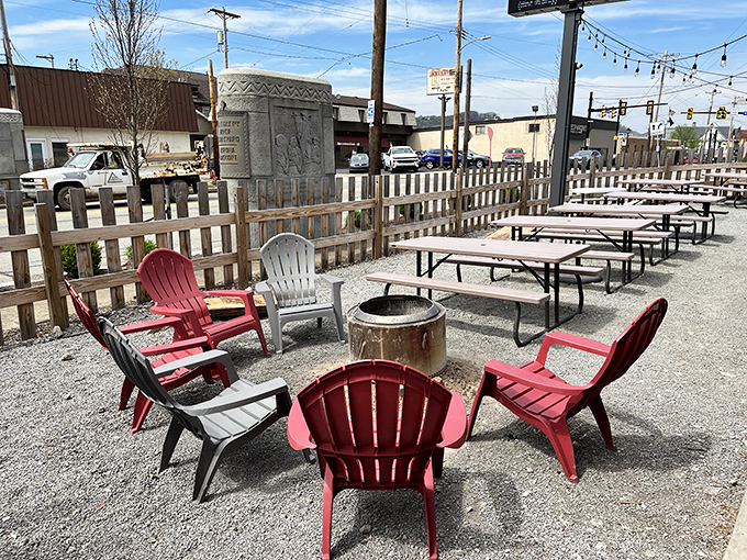 The outdoor seating area, where Adirondack chairs circle fire pits like a modern campfire, inviting you to settle in and debate the merits of dry rub versus sauce.