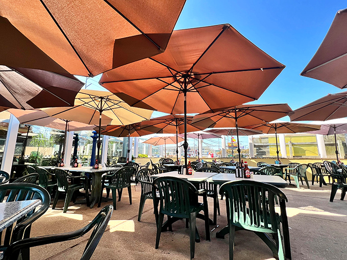 The outdoor seating area, where umbrellas create islands of shade perfect for enjoying breakfast with a side of people-watching.