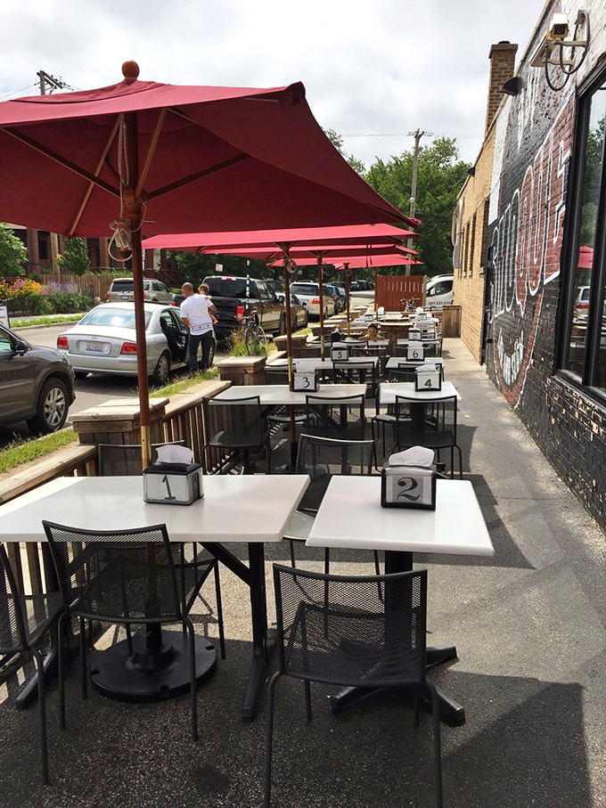 The outdoor patio: where summer dreams and barbecue steam mingle under cheerful red umbrellas. Al fresco never tasted so good.