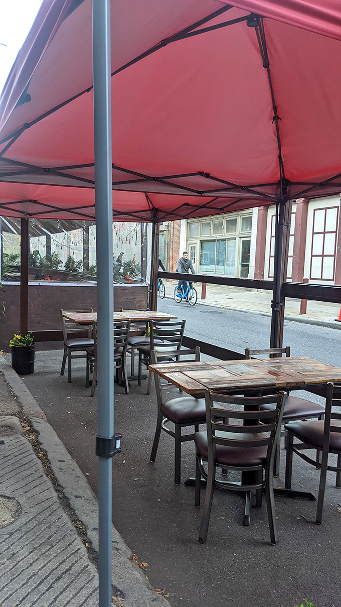 Outdoor seating under a simple red canopy &ndash; because sometimes a sandwich this good deserves fresh air and people-watching opportunities.