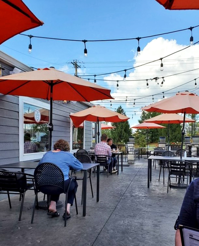 The outdoor patio offers a perfect summer setting for enjoying those criminally delicious milkshakes under string lights and blue skies.