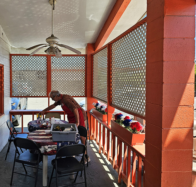 Even the outdoor seating area maintains the orange theme, offering a shaded spot to enjoy your meal while watching small-town life unfold.