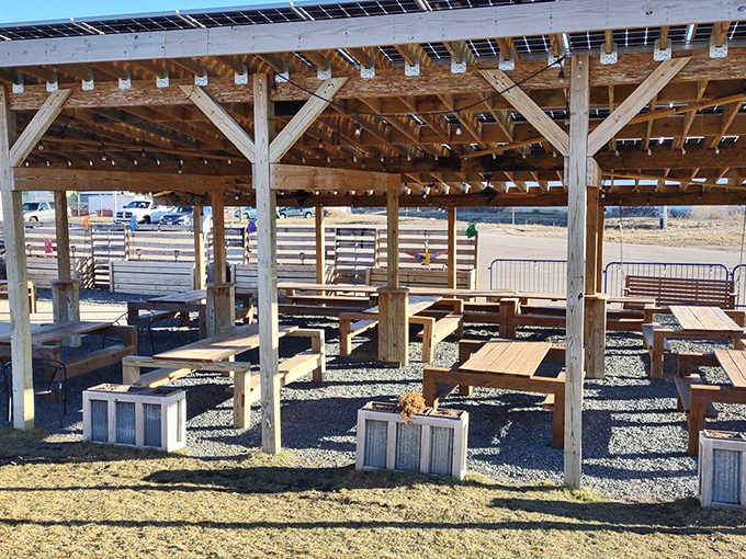 Outdoor seating under rustic beams offers a casual alternative for summer evenings, where conversations flow as freely as the drinks.