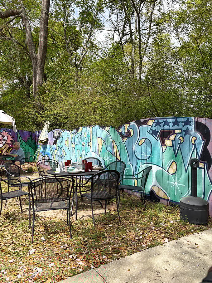 The secret garden of Woodchuck's &ndash; where outdoor tables nestled against street art create an unexpected urban oasis for alfresco dining.