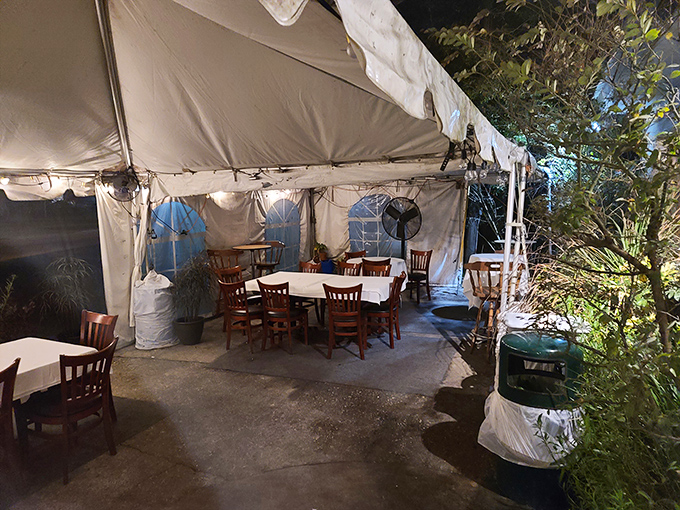Outdoor seating under canvas offers a breezy Florida dining alternative. Nature and nurture in perfect harmony.