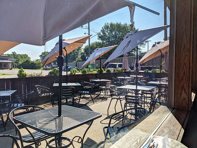 The outdoor patio at Greenbush&mdash;where summer afternoons turn into evening memories. Those umbrellas don't just provide shade&mdash;they frame perfect Michigan moments.