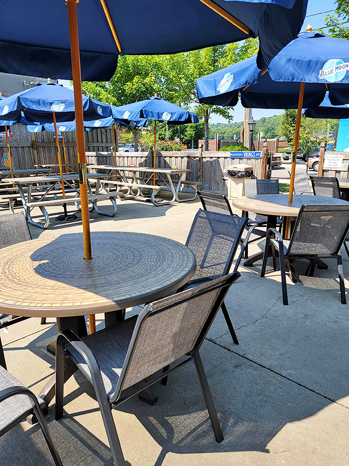 The outdoor patio with its blue umbrellas offers a perfect summer retreat. Al fresco dining where sports talk and laughter flow as freely as the drinks.