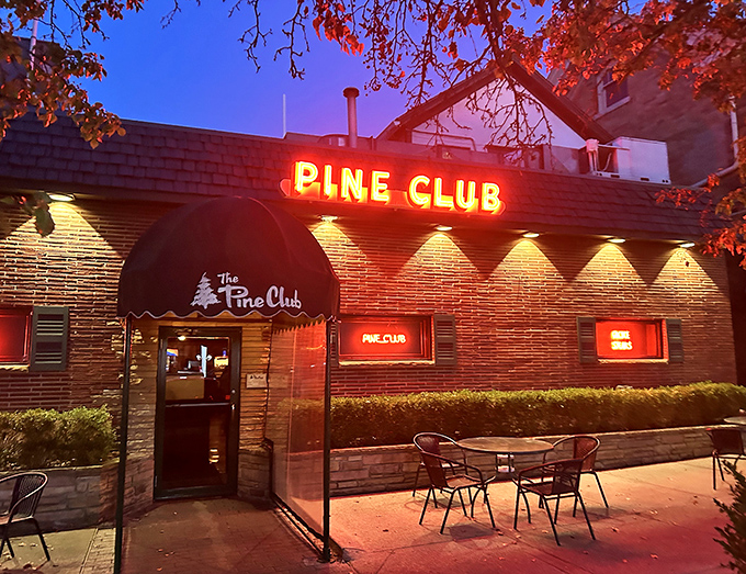 As dusk falls, The Pine Club's neon sign glows like a promise &ndash; inside these brick walls, dinner isn't just a meal, it's an institution.