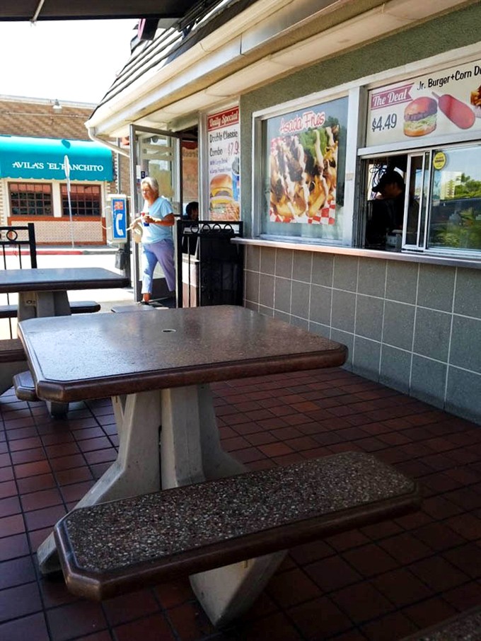 Outdoor seating for those who prefer their burger with a side of people-watching. That concrete table has hosted more meaningful conversations than most conference rooms.