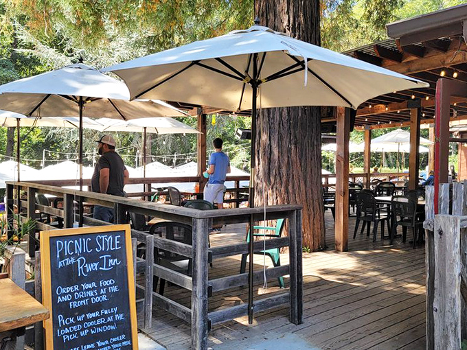 "Picnic Style at the River Inn" isn't just a sign—it's an invitation to slow down and savor. The redwood standing guard approves.
