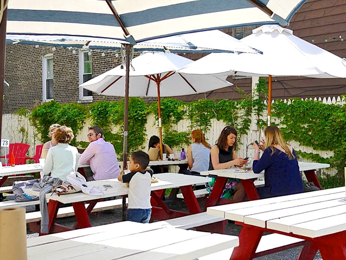 Picnic tables under white umbrellas create the perfect setting for that most sacred of summer activities: eating pie while pretending to listen to your companions.
