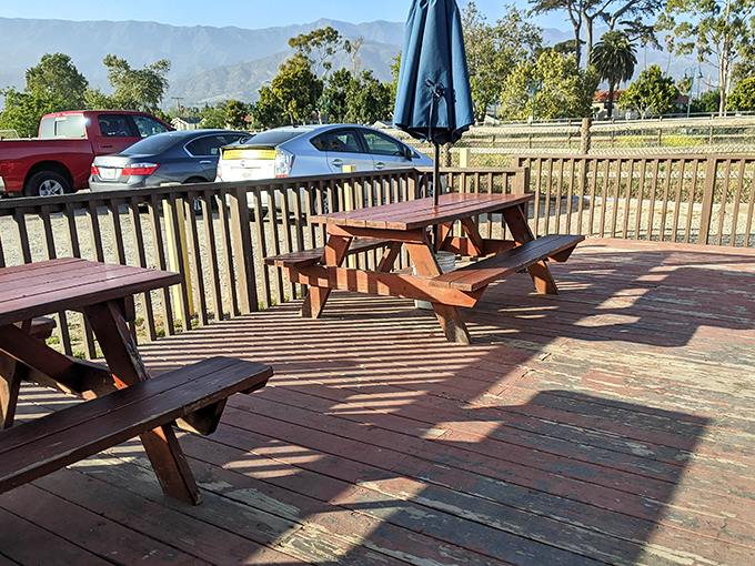 Wooden picnic tables with million-dollar mountain views – The Spot proves that sometimes the best dining rooms have no walls at all.