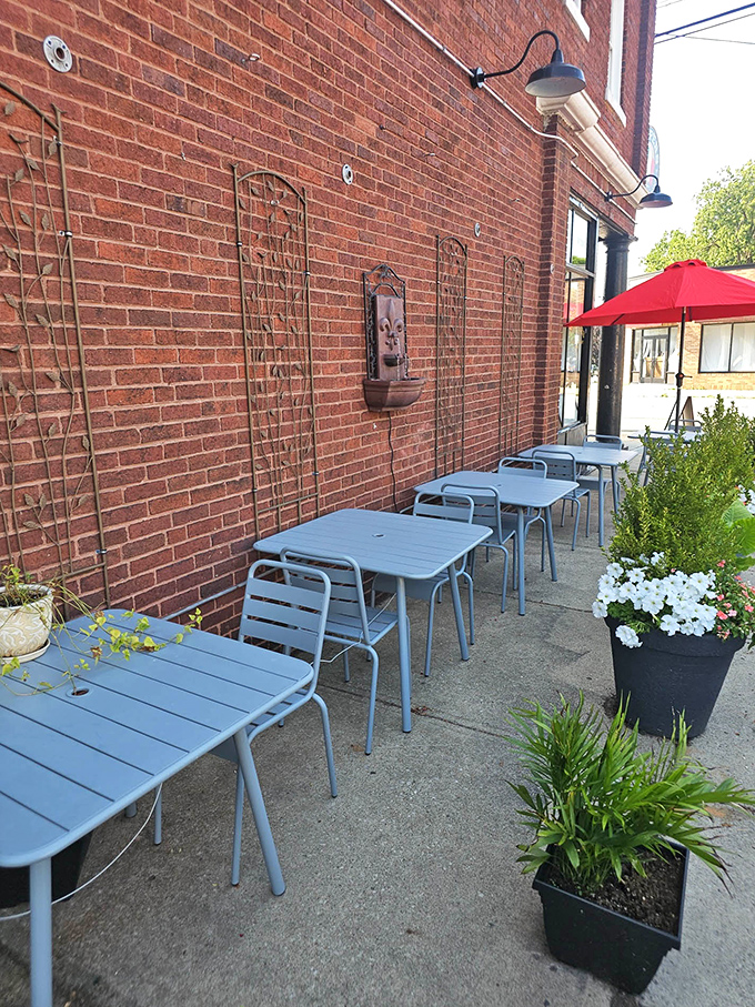 The simplicity of blue tables against brick walls creates the perfect backdrop for conversation. Add a glass of wine and suddenly Tuesday feels like vacation.