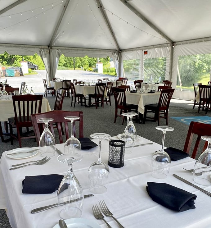 White tablecloths under a tent create an elegant outdoor experience where even Mother Nature dresses up for dinner.