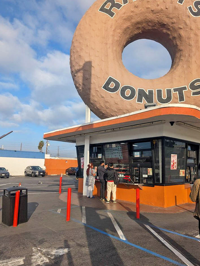 The pilgrimage to Randy's isn't complete without the ritual wait beneath the great donut&mdash;a small price for such sweet rewards.