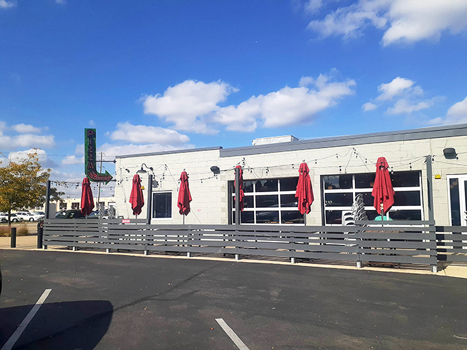 The outdoor seating area awaits warmer days, where pizza and sunshine create the perfect Ohio afternoon. Those red umbrellas have sheltered countless pizza-induced food comas.