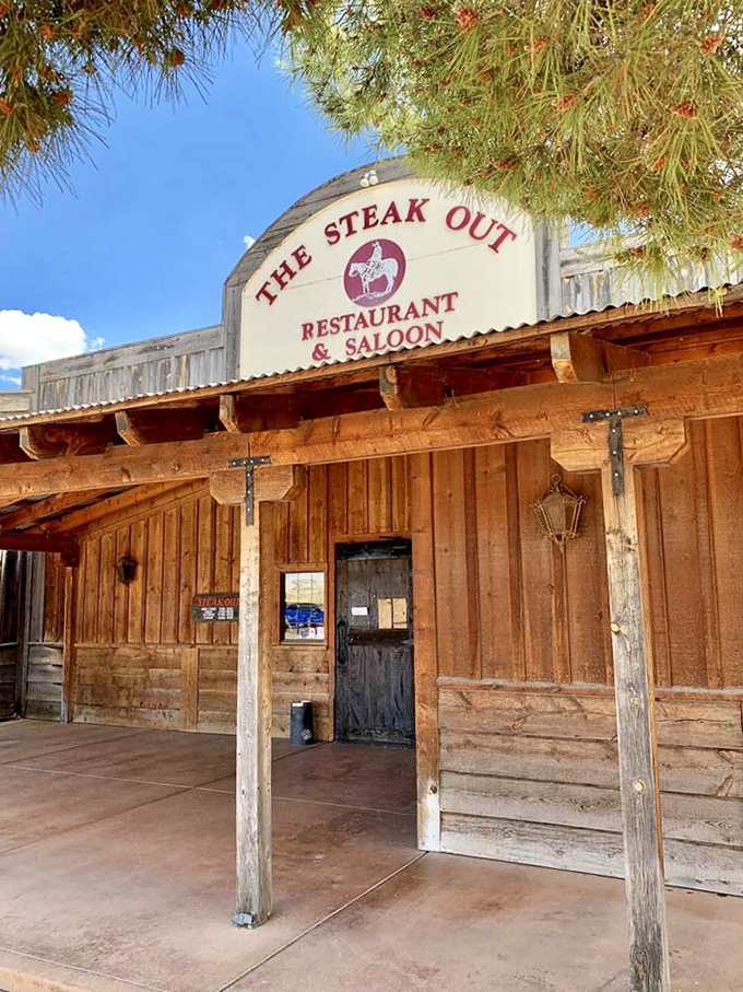 Framed by pine trees and blue sky, The Steak Out's entrance is like a portal to a time when meals were events and beef was king.