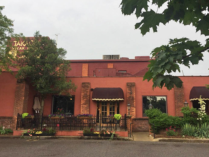 The charming exterior patio invites you to dine al fresco, where brick, blooms, and burgundy awnings create Fort Wayne magic.