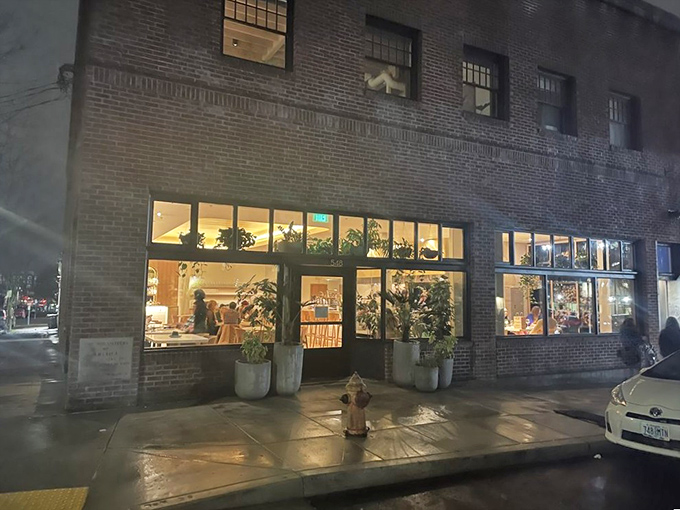 As night falls, Kann glows like a lantern of culinary promise. The brick building houses treasures that have made it one of Portland's most sought-after dining destinations.