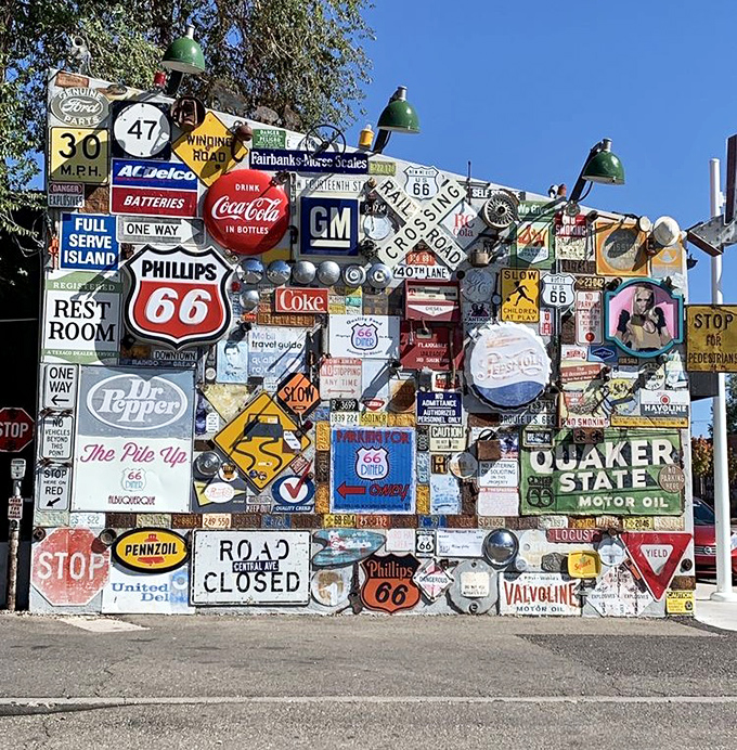 Not just a wall of signs—it's America's roadside history stacked higher than your appetite after seeing the dessert menu.