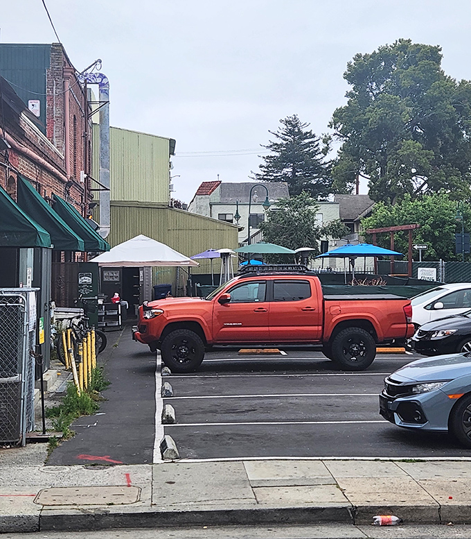 The back parking area reveals the restaurant's humble exterior&mdash;proof that culinary treasures often hide in the most unassuming packages.