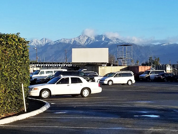 Even the parking lot offers a view! Snow-dusted mountains frame this bargain hunter's paradise, where nature's majesty meets retail therapy.