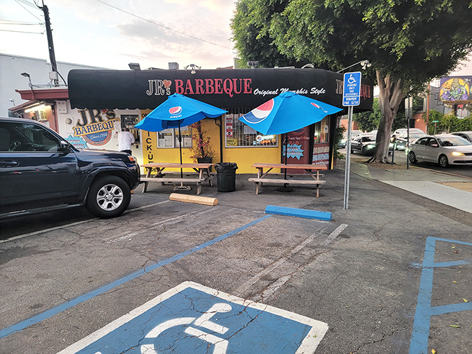 Outdoor seating under Pepsi umbrellas – not fancy, but who needs ambiance when you've got a tray of smoky perfection headed your way?