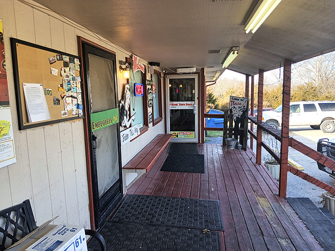 The weathered wooden porch with its red railings serves as the diner's front line, where the aroma of home cooking first greets hungry visitors.