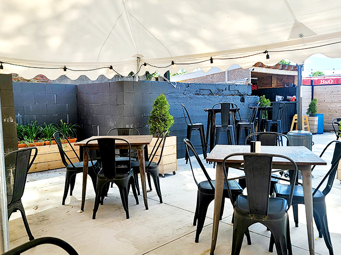 The outdoor patio where summer breezes complement every bite, proving that good food tastes even better under open skies. 