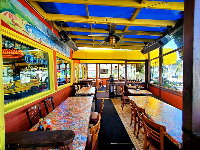 The covered patio offers a bright, cheerful space where those nautical-themed tablecloths remind you exactly why you came.