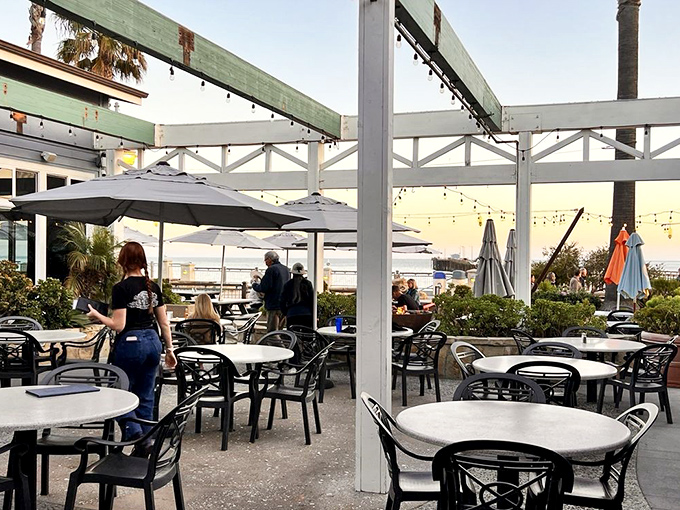 The patio at Custom House&mdash;where ocean breezes enhance every bite and the setting sun turns dinner into a California postcard moment.