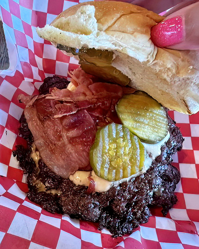 This burger's lacy, crispy edges extend beyond the bun—the hallmark of smash burger perfection that burger aficionados dream about.